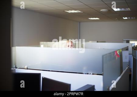 Putting in some extra hours. Portrait of an attractive young woman standing in her office ...