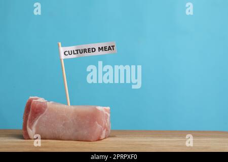 Sample of lab grown pork labeled Cultured Meat on wooden table Stock ...