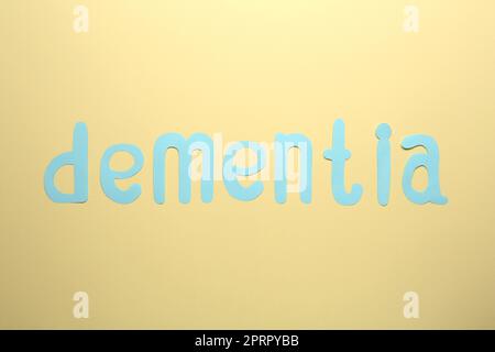 Word Dementia made of paper letters and pills on beige background, flat ...