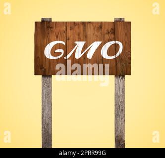 Wooden sign with abbreviation GMO and green leaves on white background ...