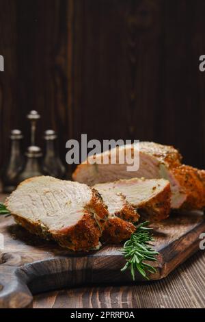 Closeup view of pork collar joint baked in oven on wooden serving board ...