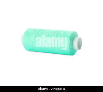 Spool of turquoise sewing thread isolated on white Stock Photo - Alamy