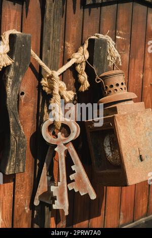Vintage key hanging on a rope on a gold background Stock Photo - Alamy