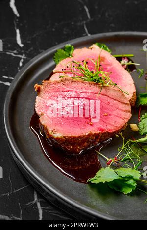 sliced medium rare fillet mignon steak on wood board Stock Photo - Alamy