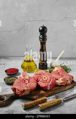 Raw lamb meat leg steak on a stone board. Black background. Top view ...
