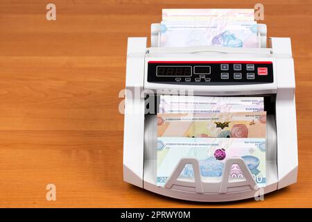 Uzbekistani money in the counting machine Stock Photo - Alamy