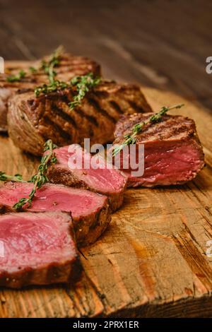 Closeup view of grilled tri-tip loin beef steaks medium rare with fresh ...