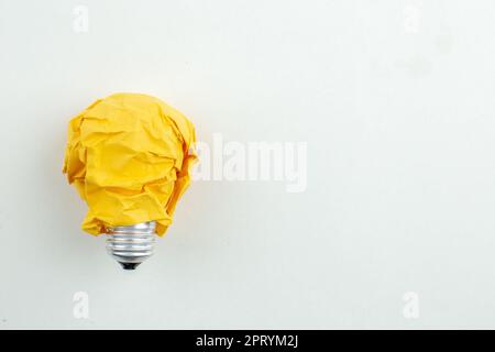 top view yellow idealight bulb on white background with free space ...