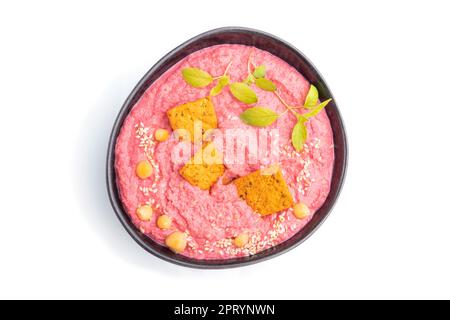 Hummus with beet and microgreen basil sprouts in ceramic bowl on a ...