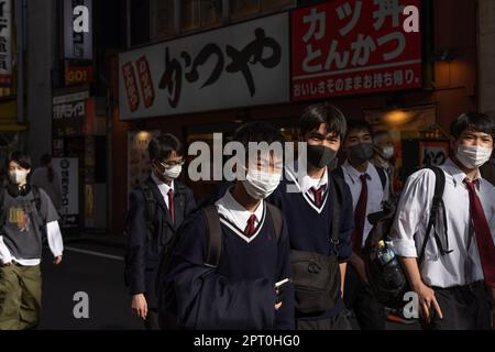 Japanese students with face masks walk in Akihabara, Tokyo Stock Photo ...