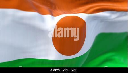 Close-up view of the Niger national flag waving. Republic of the Niger ...