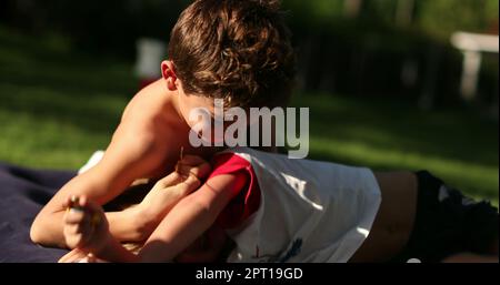 Siblings fighting each other outdoors, real life quarrel authentic ...