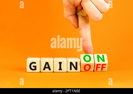 Gain on or off symbol. Businessman turns wooden cubes and changes word ...