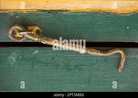 hook old brass window Used to attach doors or windows Stock Photo - Alamy