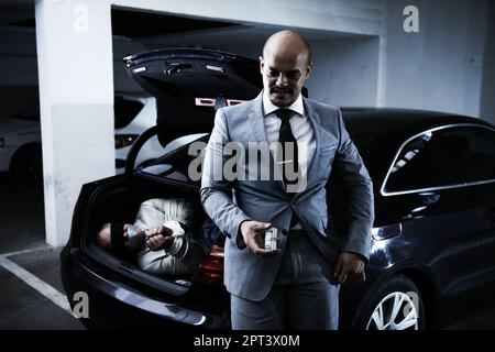 Easy money. A gangster eyeing a roll of notes greedily after a ...