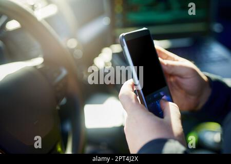 Checking is text alerts. an unrecognizable male police officer using ...