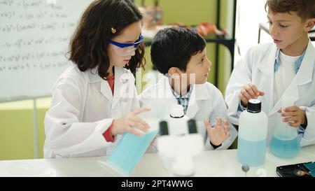 Group of kids students pouring liquid on bottl doing experiment at ...