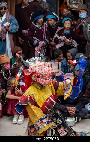 A masked Monk dances in front of the crowd at the Stongdey Monastery ...