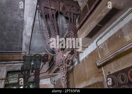 Chains from a pulley block of a former paper factory, Lost Place, Baden ...