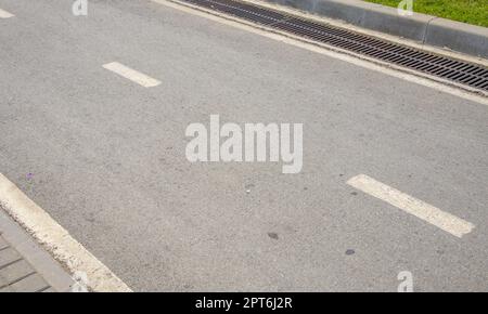 Road markings. An intermittent white stripe on an asphalt road. Urban ...