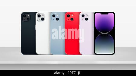 Modern smartphones of different colors standing on the table, white ...