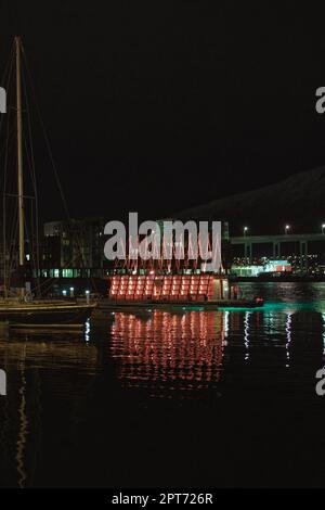 Vertical shot of the Sauna house in Tromso harbor at night. Norway ...