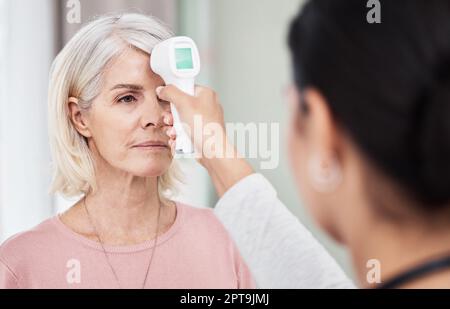 Your temperature will determine the next step. a senior woman having ...