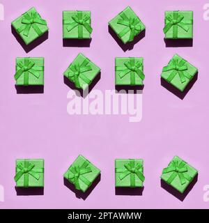 Many small green gift boxes on texture background of fashion trendy ...