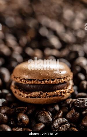 Sweet macaron dessert with coffee beans on the black table Stock Photo ...