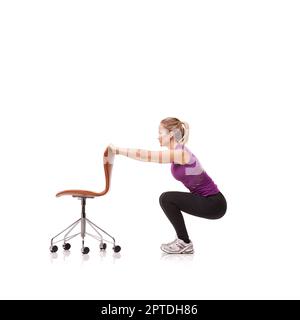 Keeping her legs lean. A beautiful young woman wearing gym clothes and ...