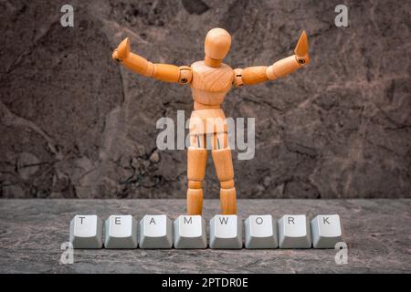 Mannequin standing next to computer keyboard keys arranged to spell ...