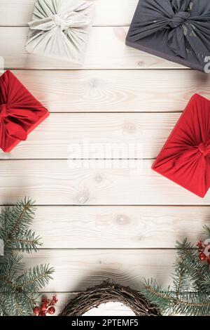 Group of christmas presents in furoshiki package, top view. Spruce ...