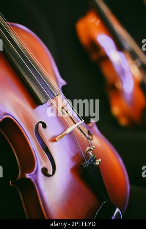Detail view of two violins on some chairs Stock Photo - Alamy