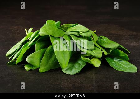 Leavews of fresh spinach on dark background Stock Photo - Alamy