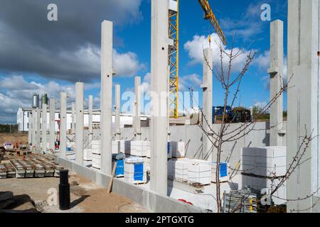 many concrete pillars for a factory building are erected on a ...