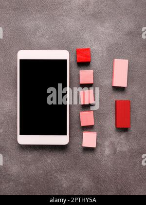 Playing some games on her tablet. High angle shot of a young woman ...