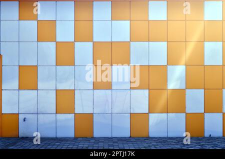 The texture of the metal wall, framed in the form of colored squares of ...