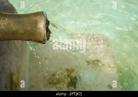 Water permanently flowing from a pipe of a public fountain. Concept of ...