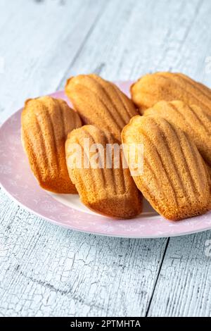 Madeleines - French small sponge cakes on the stone board Stock Photo ...