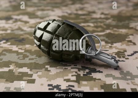 Hand grenade on digital camouflage fabric. Space for text Stock Photo ...
