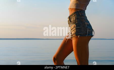 Female hips and belly with bronze tan skin on the beach at sunset Stock ...