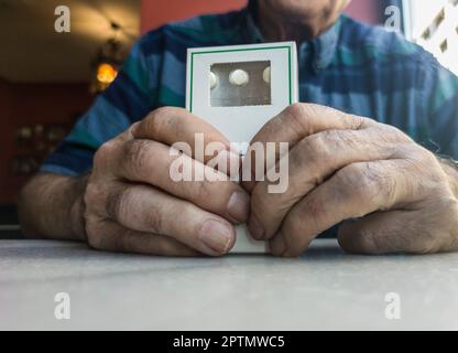 Old man holds a box of pills. Inappropriate use of medication by ...