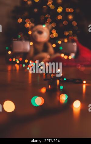 Defocused Christmas Theme Photo. Bear with Presents Under Glowing Xmas ...