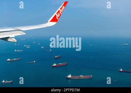 Aerial view of cargo ships queues to enter in Singapore harbor ...