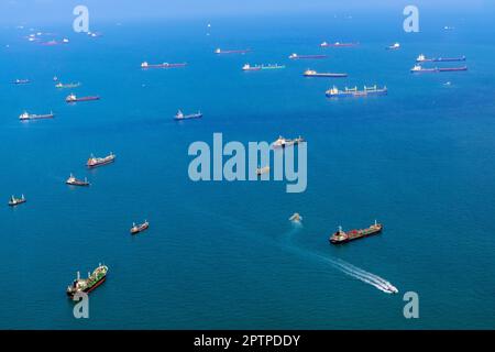 Aerial view of cargo ships queues to enter in Singapore harbor ...