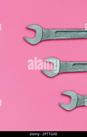 Metallic spanner lie on texture background of fashion pastel pink color ...