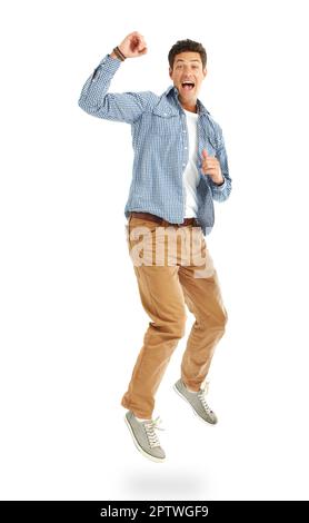 Leaping with positivity. Handsome young guy jumping energetically ...