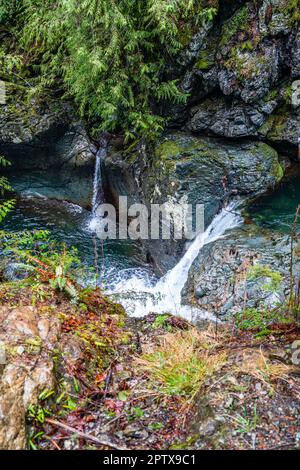 Water flows through a rock outlet below Twin Falls in Washington State ...