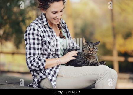 Normal girl strokes normal cat in normal forest. Isn't everything ...