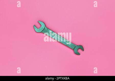 Metallic spanner lie on texture background of fashion pastel pink color ...